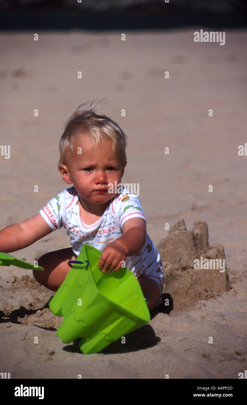 Little boy playing with bucket and spade on beach Stock Photo - Alamy