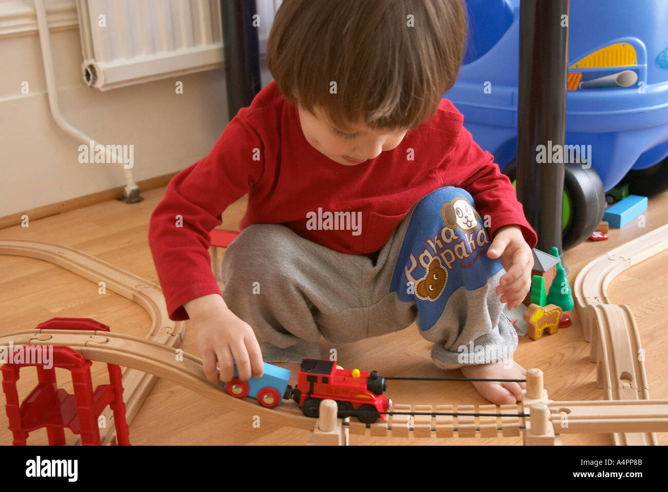 Young boy playing with trains Stock Photo - Alamy