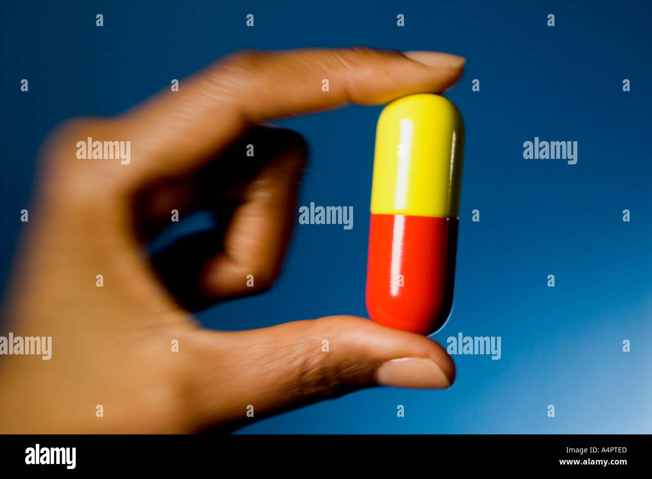 Hand holding capsule pill Stock Photo - Alamy