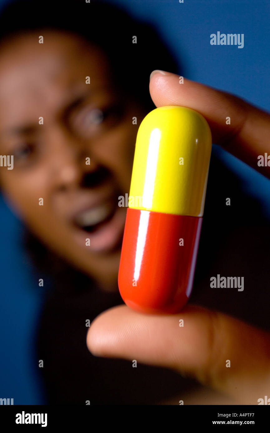 Hand holding capsule pill Stock Photo - Alamy