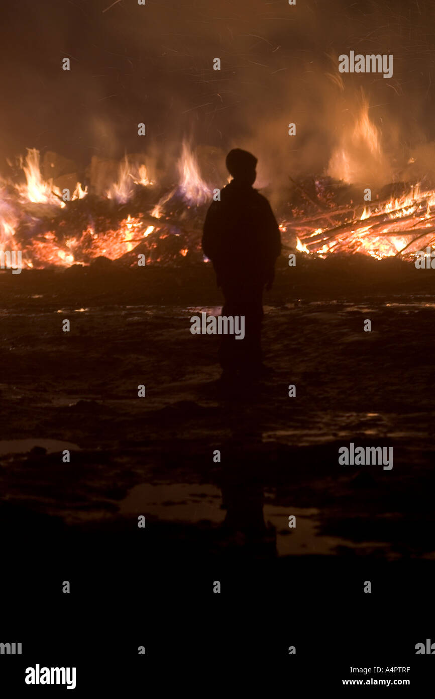 Silhouette of a person standing near a forest fire Stock Photo - Alamy