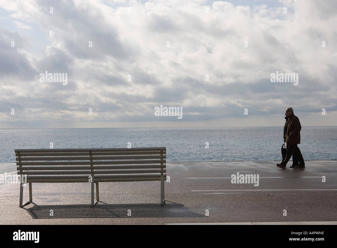 Side profile of two people walking on the sidewalk Stock Photo - Alamy