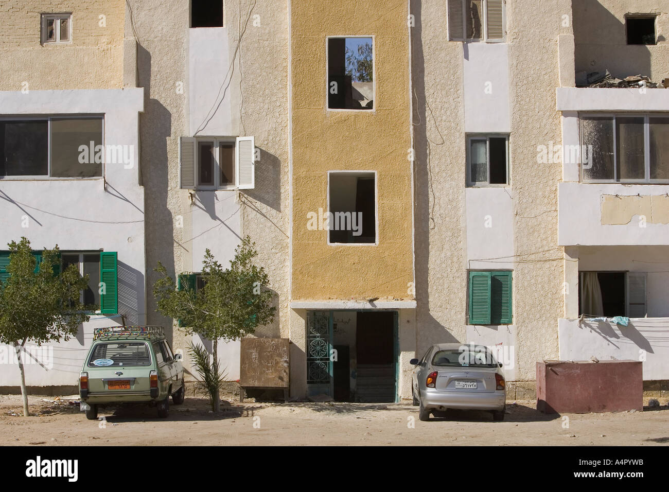 Cars parked in front of a building Stock Photo - Alamy