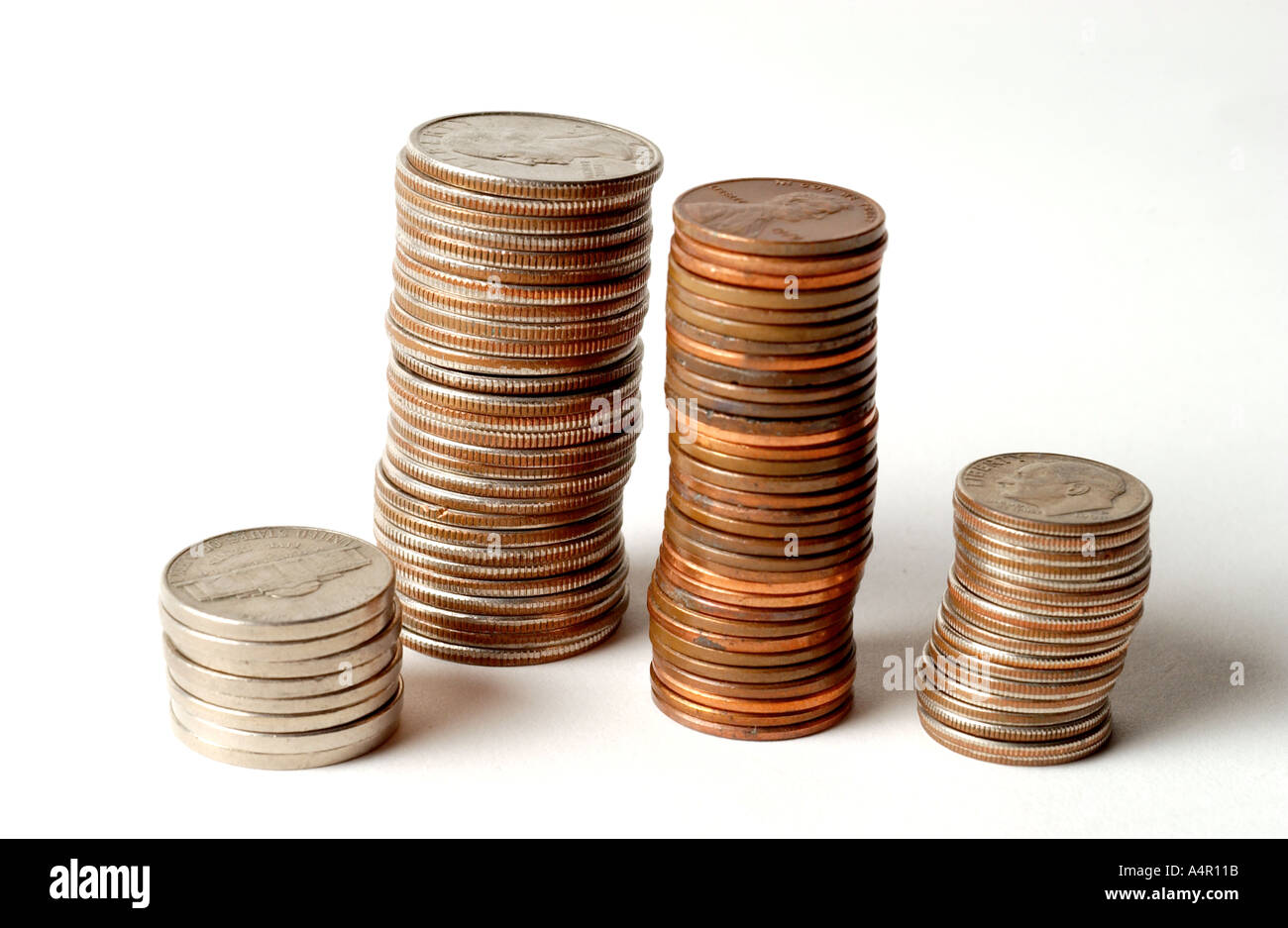 Stacks of various coins on a white background Stock Photo - Alamy