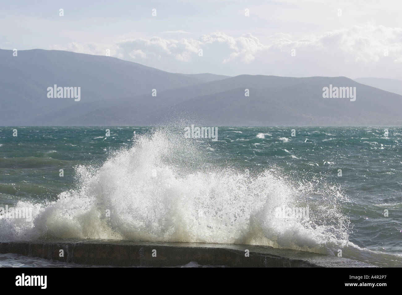 Waves breaking on a concrete barrier Stock Photo - Alamy