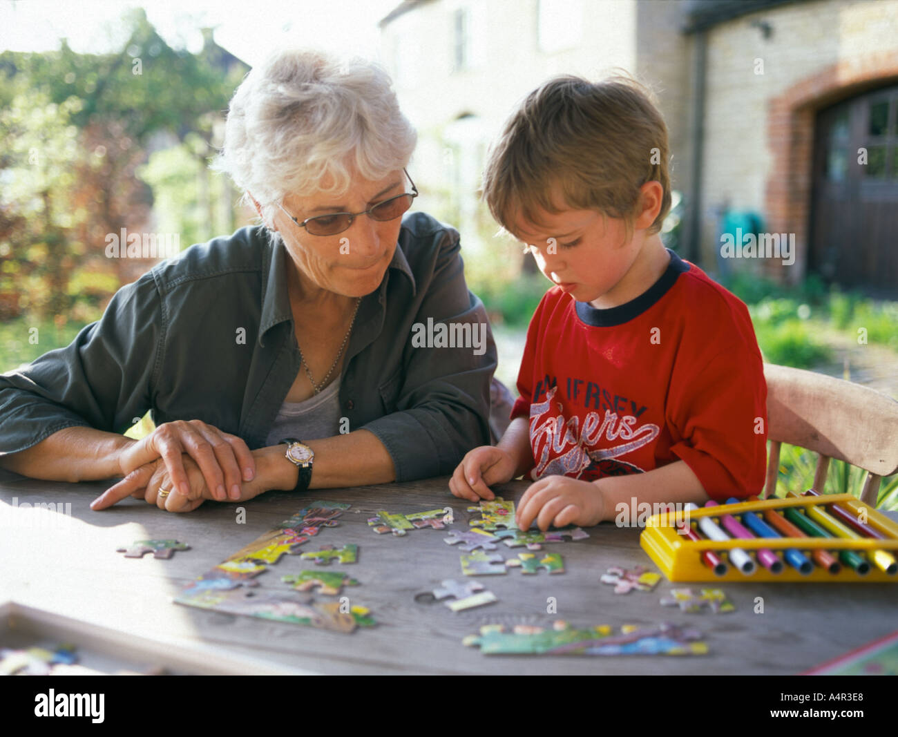 Child doing jigsaw hi-res stock photography and images - Alamy