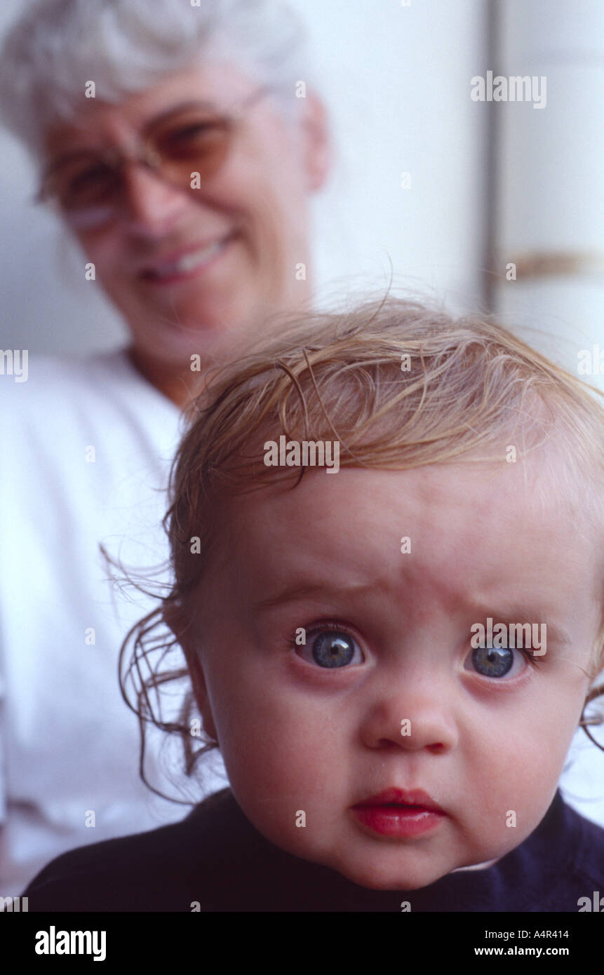 baby sitting grandmother lap content toddler boy Stock Photo - Alamy