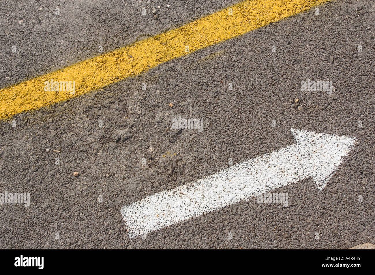 Close up of a road arrow sign and road markings Stock Photo - Alamy