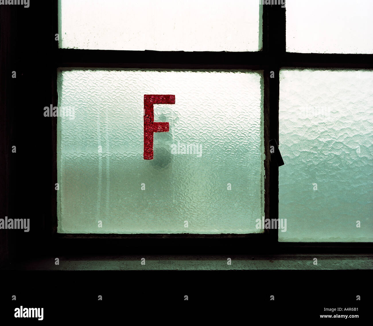 F-letter on frosted glass Stock Photo - Alamy