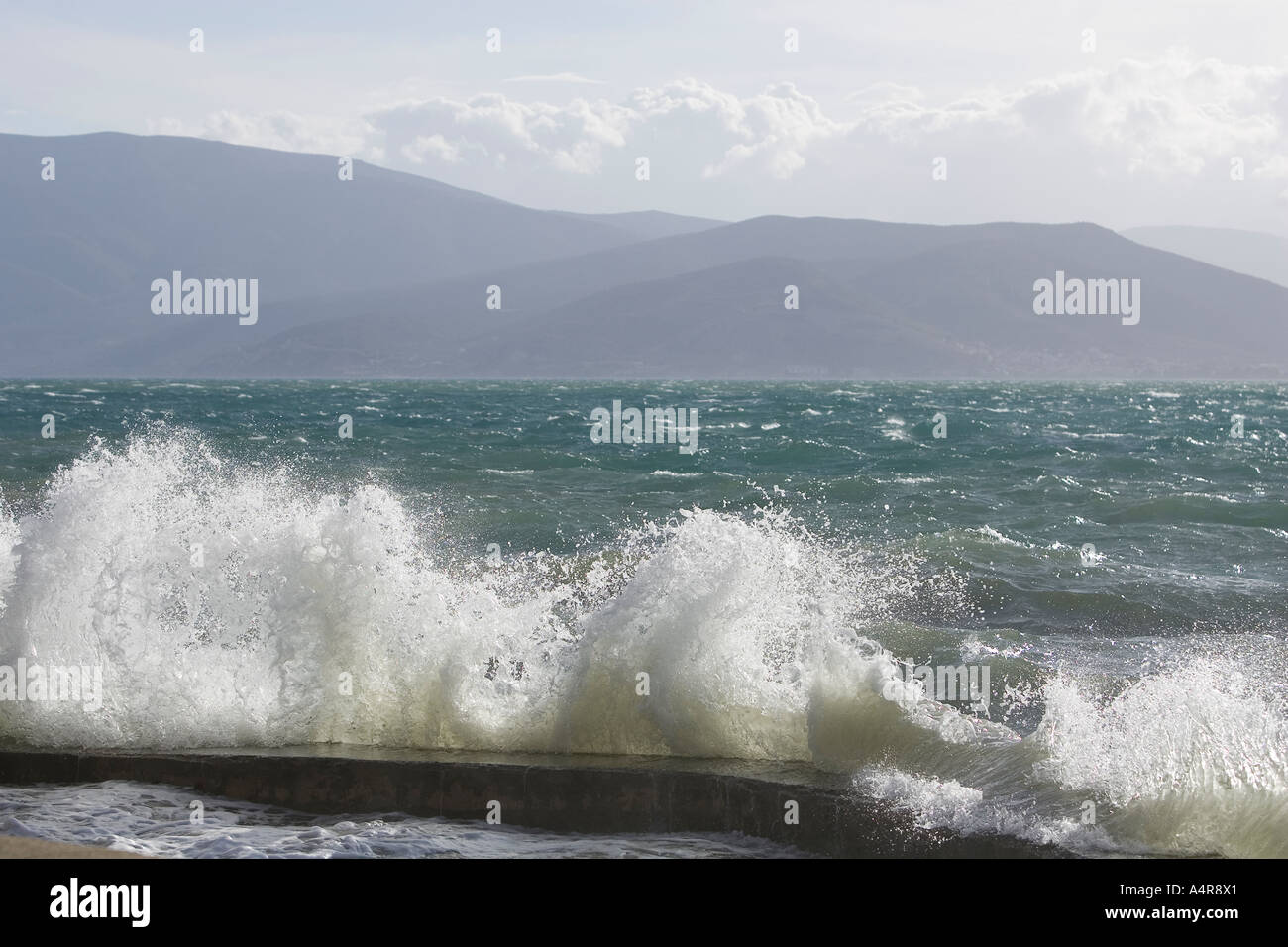 Waves breaking on a concrete barrier Stock Photo - Alamy