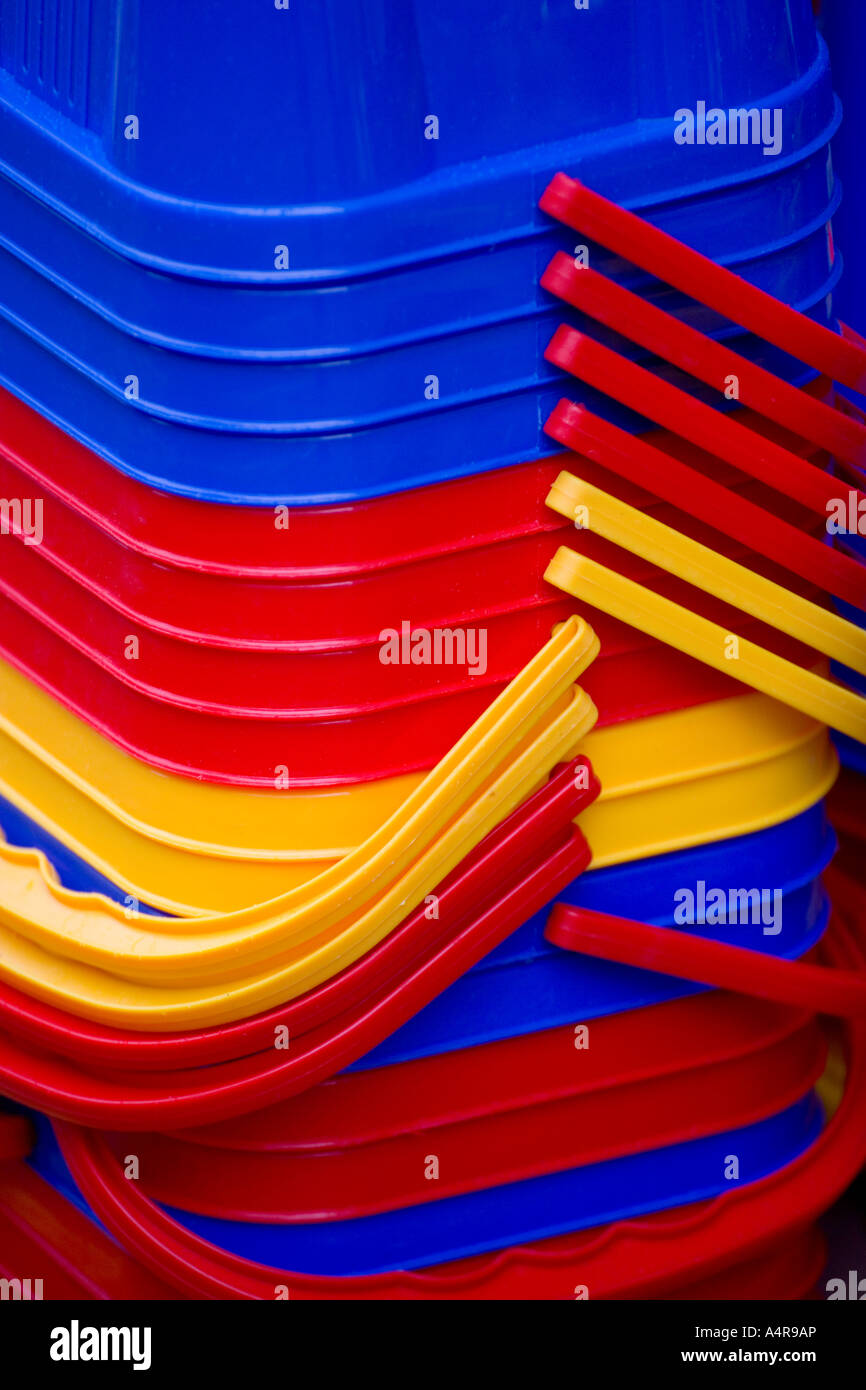 Multi coloured buckets for sale at the sea side Stock Photo - Alamy