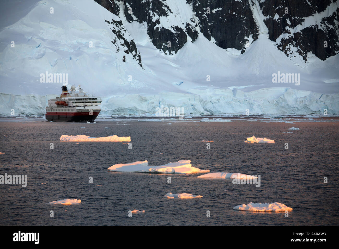 Ship navigating through sea ice in the Lamaire Channel in Antarctica ...