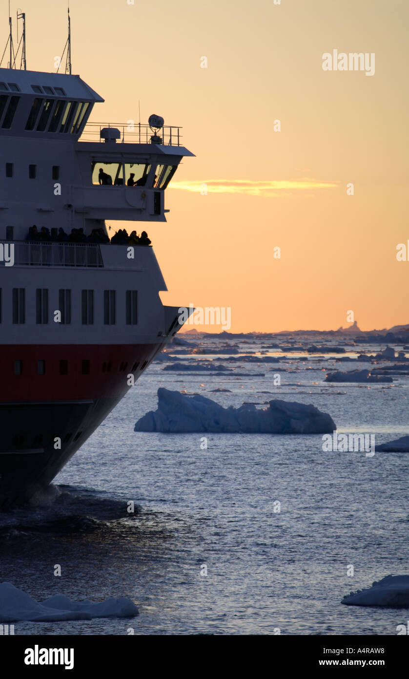 Ship navigating through sea ice in the Lamaire Channel in Antarctica ...