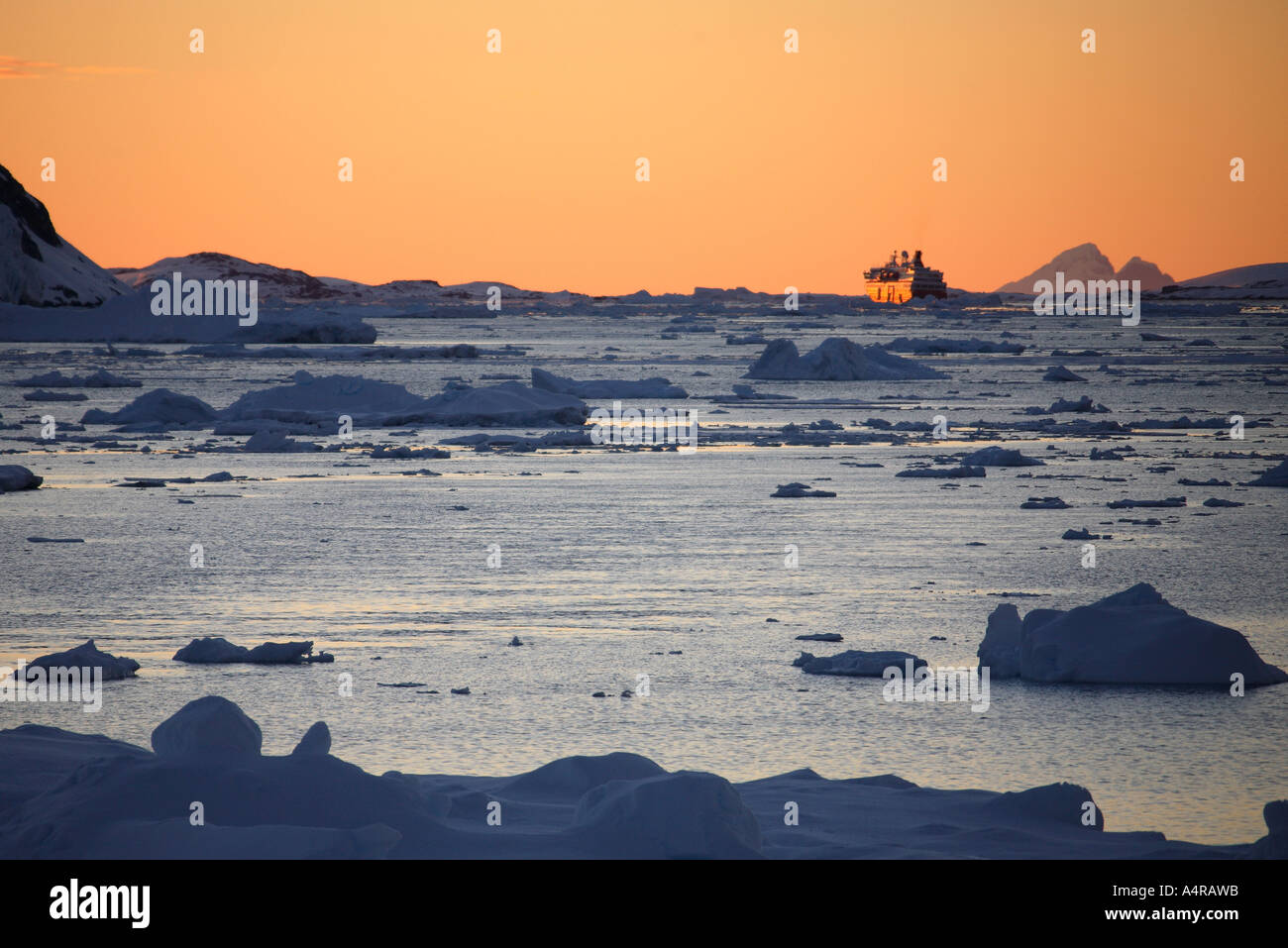 Ship navigating through sea ice in the Lamaire Channel in Antarctica ...