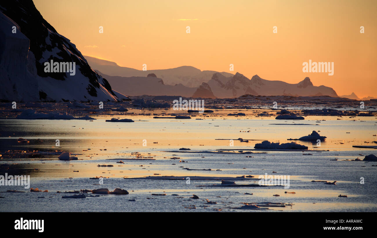An Antarctic sunset over sea ice in the Lamaire Channel in Antarctica ...