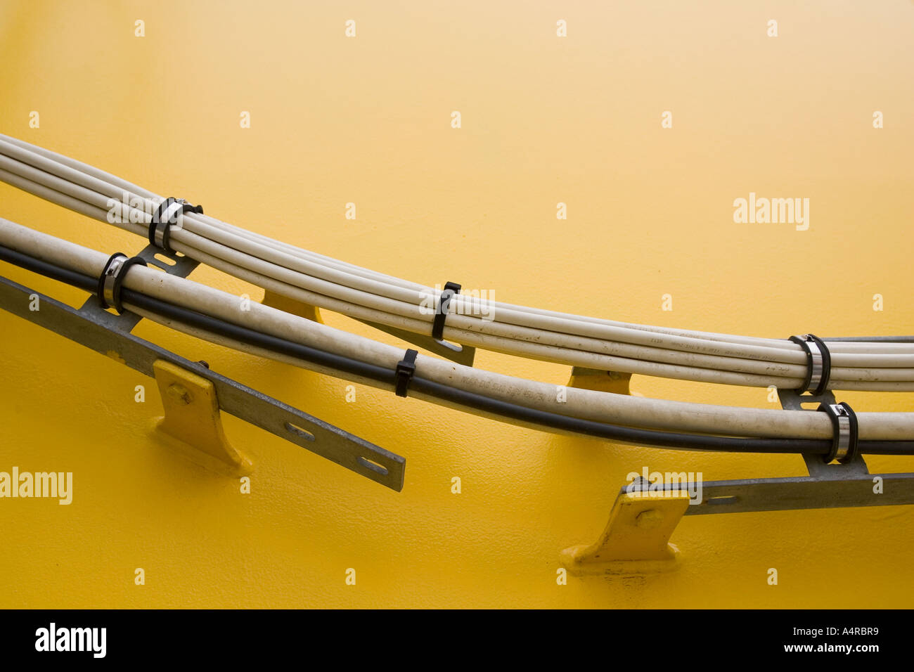Cables clamped on a metal surface Stock Photo - Alamy
