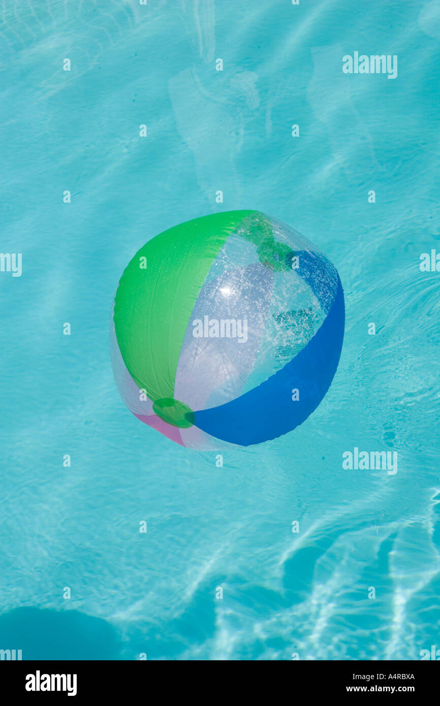 Beach ball floating in a swimming pool Stock Photo - Alamy