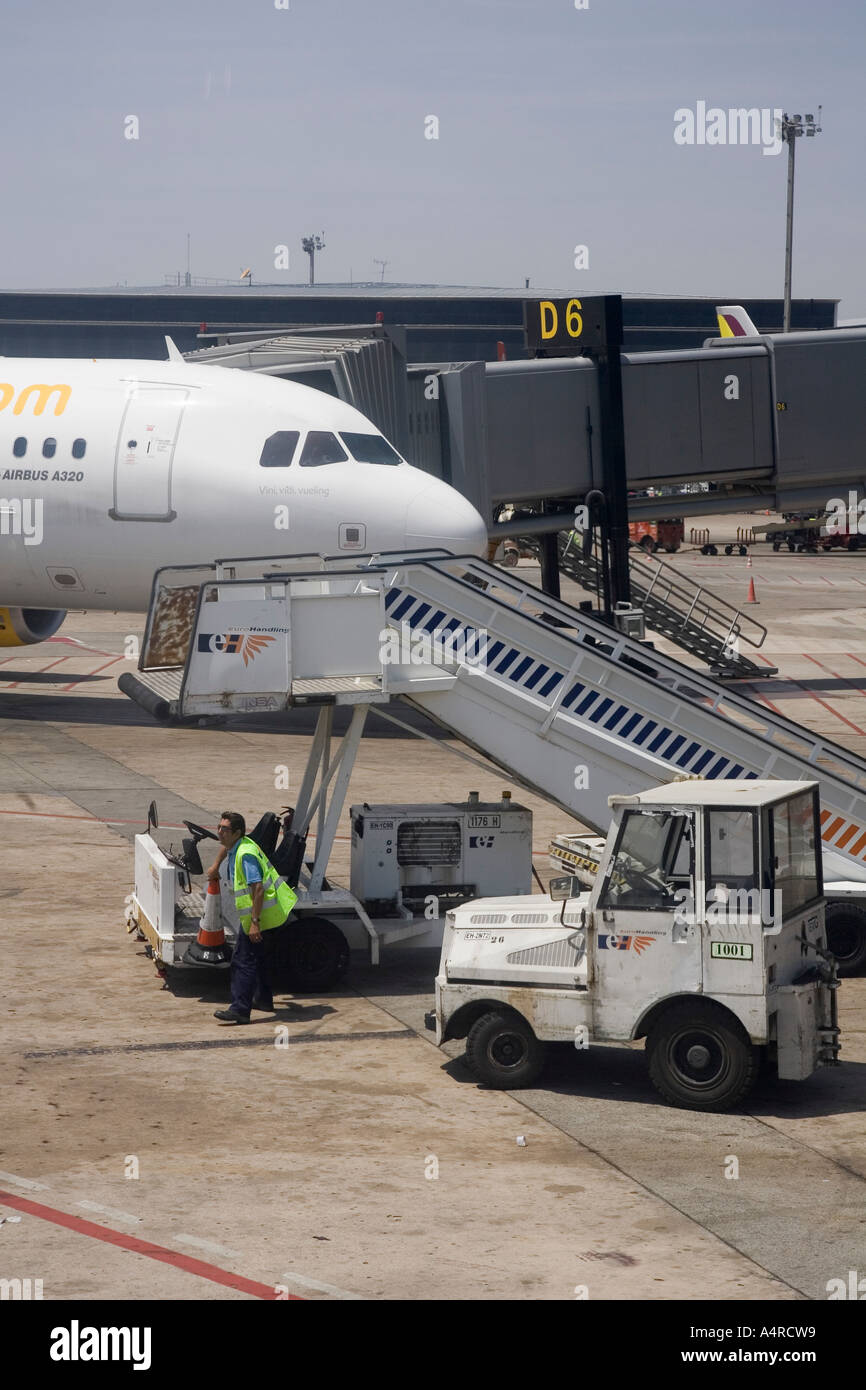 Side profile of a man holding a traffic cone at an airport runway Stock ...
