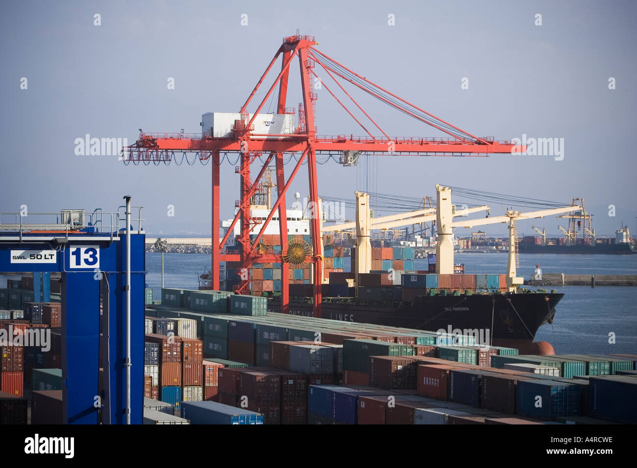 Cargo containers being lifted by cranes Stock Photo - Alamy