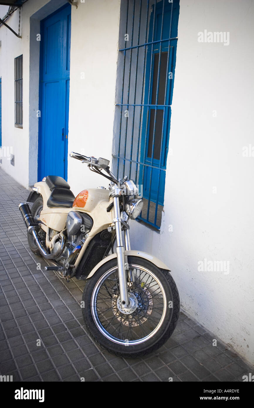 Motorcycle parked near a house window Stock Photo - Alamy