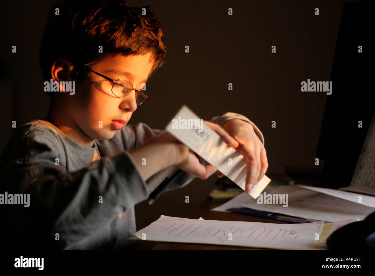Lifestyle portrait of a primary school boy as he is doing his homework ...