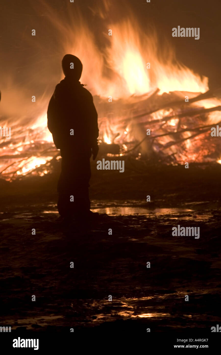 Silhouette of a person standing near a forest fire Stock Photo - Alamy