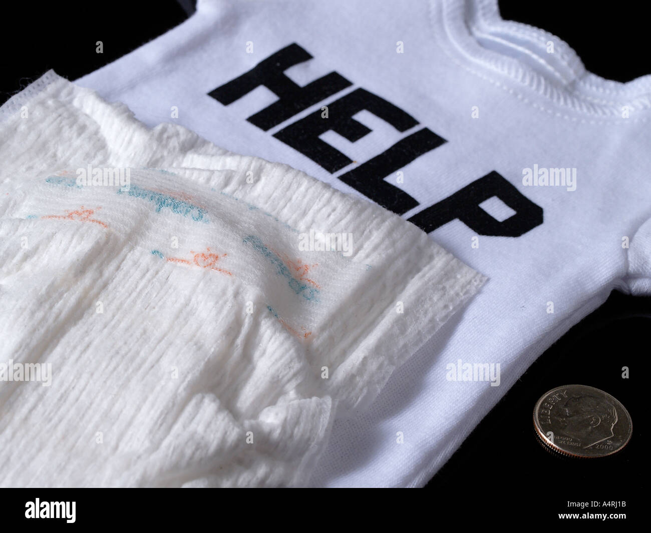 Pemature baby shirt and diaper with a coin to demonstrate the scale ...