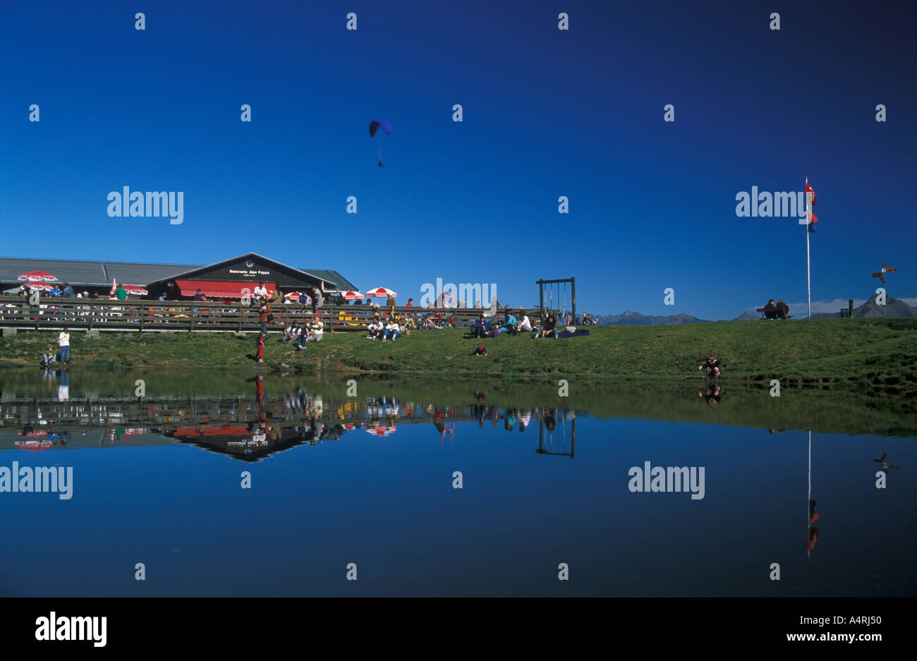 Alpe Fogga with restaurant on a weekend with vistiors and parasailer ...