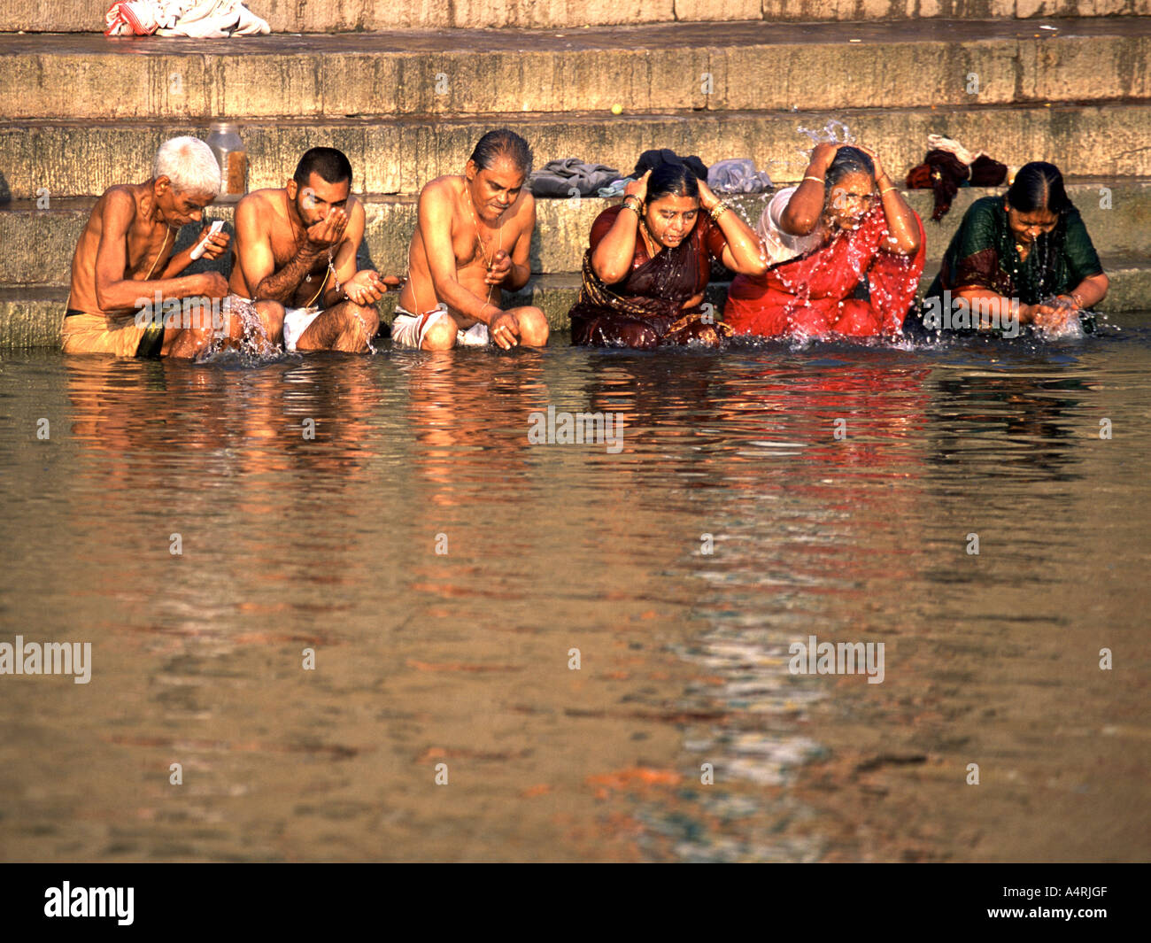 Three men and three women washing in the sacred River Ganges in ...