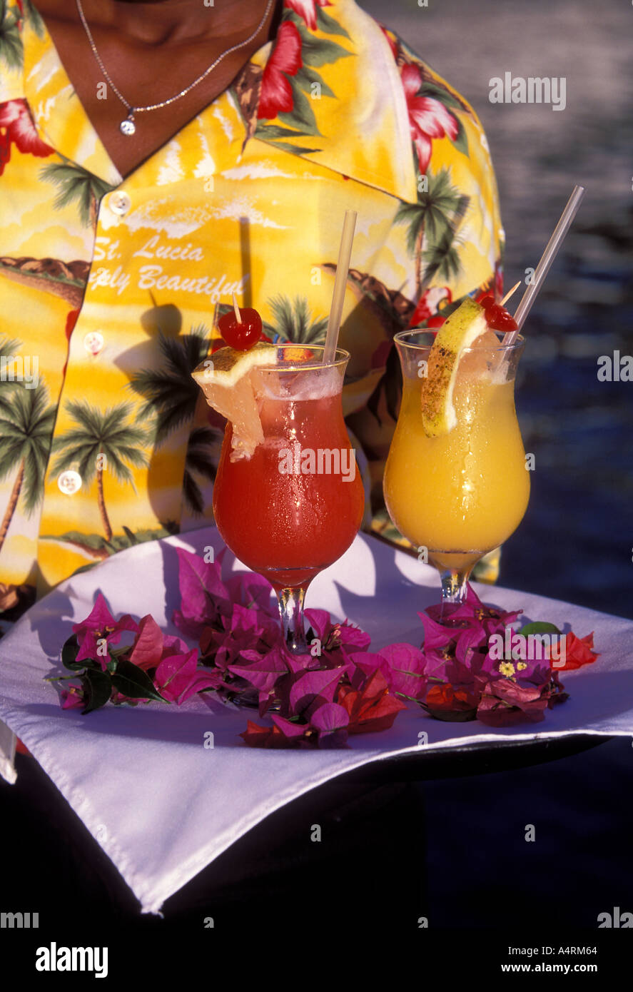 A waitress holding a tray of colorful punch drinks Marigot Bay St Lucia ...