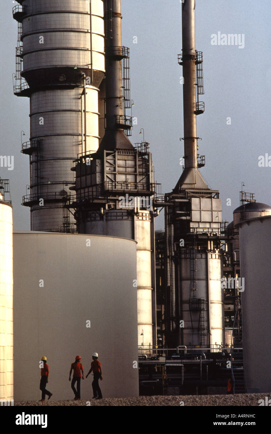 Three workers leave a petro-chemical plant after a day of working Stock ...