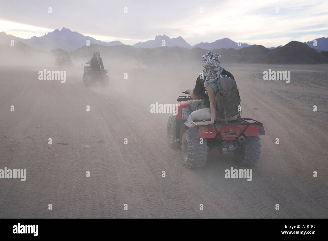 Group of people riding quad bikes in the desert Stock Photo - Alamy