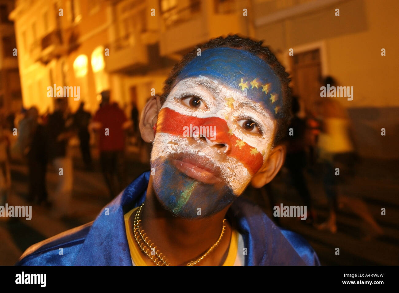 Boy at the annual carnival in Mindelo,with his face painted with the ...
