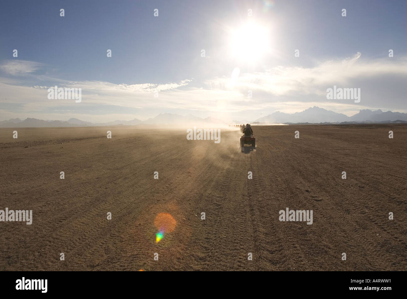 Rear view of people riding quad bikes Stock Photo - Alamy