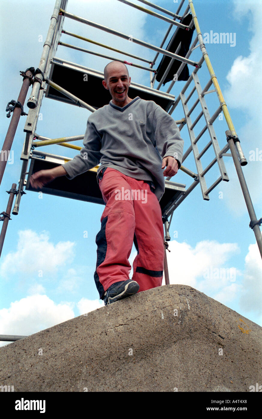Climbing down from scaffolding tower on to of rooftop at St Agnes Place ...