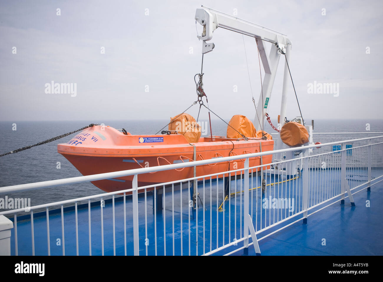 Lifeboat hanging over a deck of a ship Stock Photo - Alamy