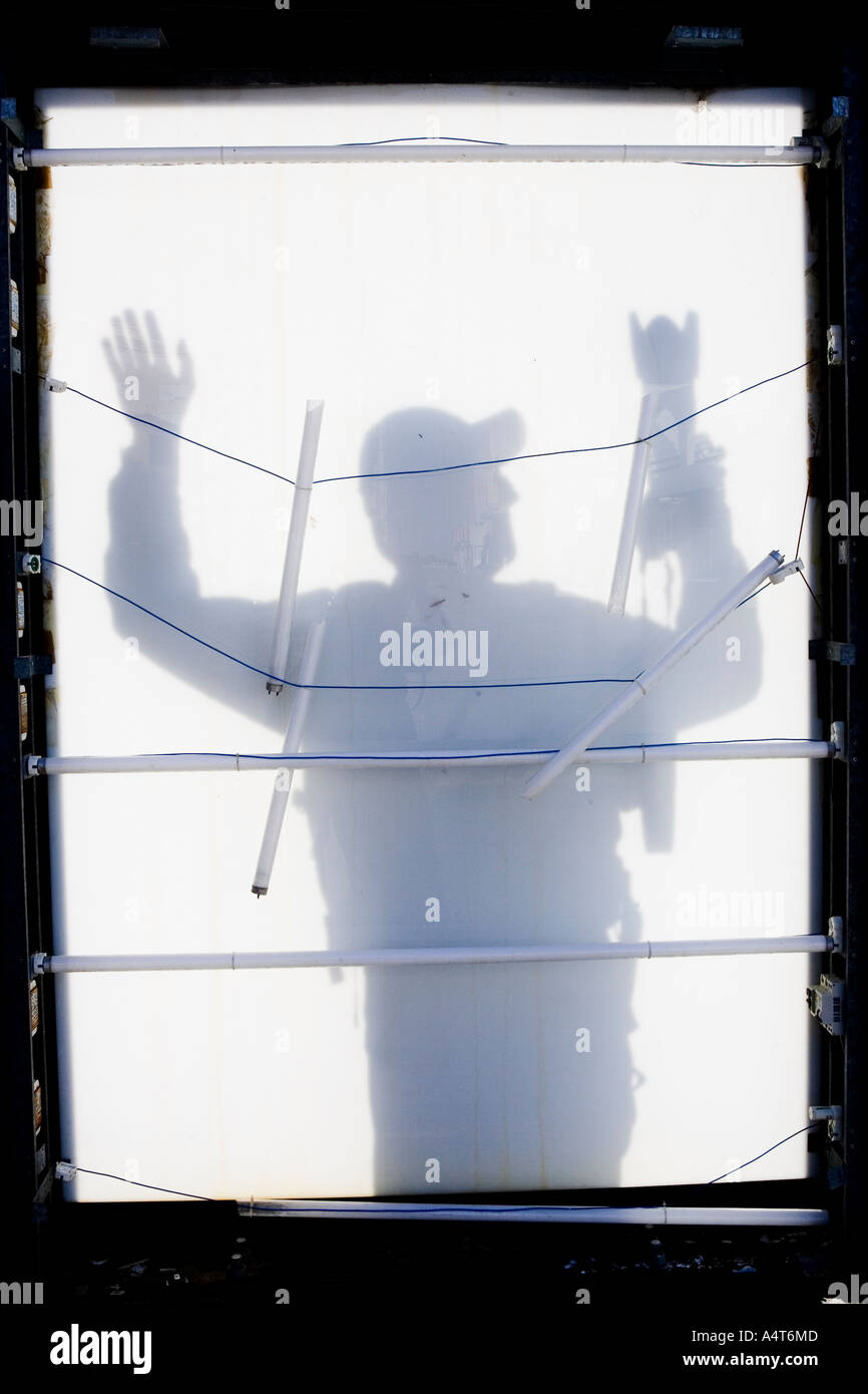 Construction worker standing behind a window Stock Photo - Alamy