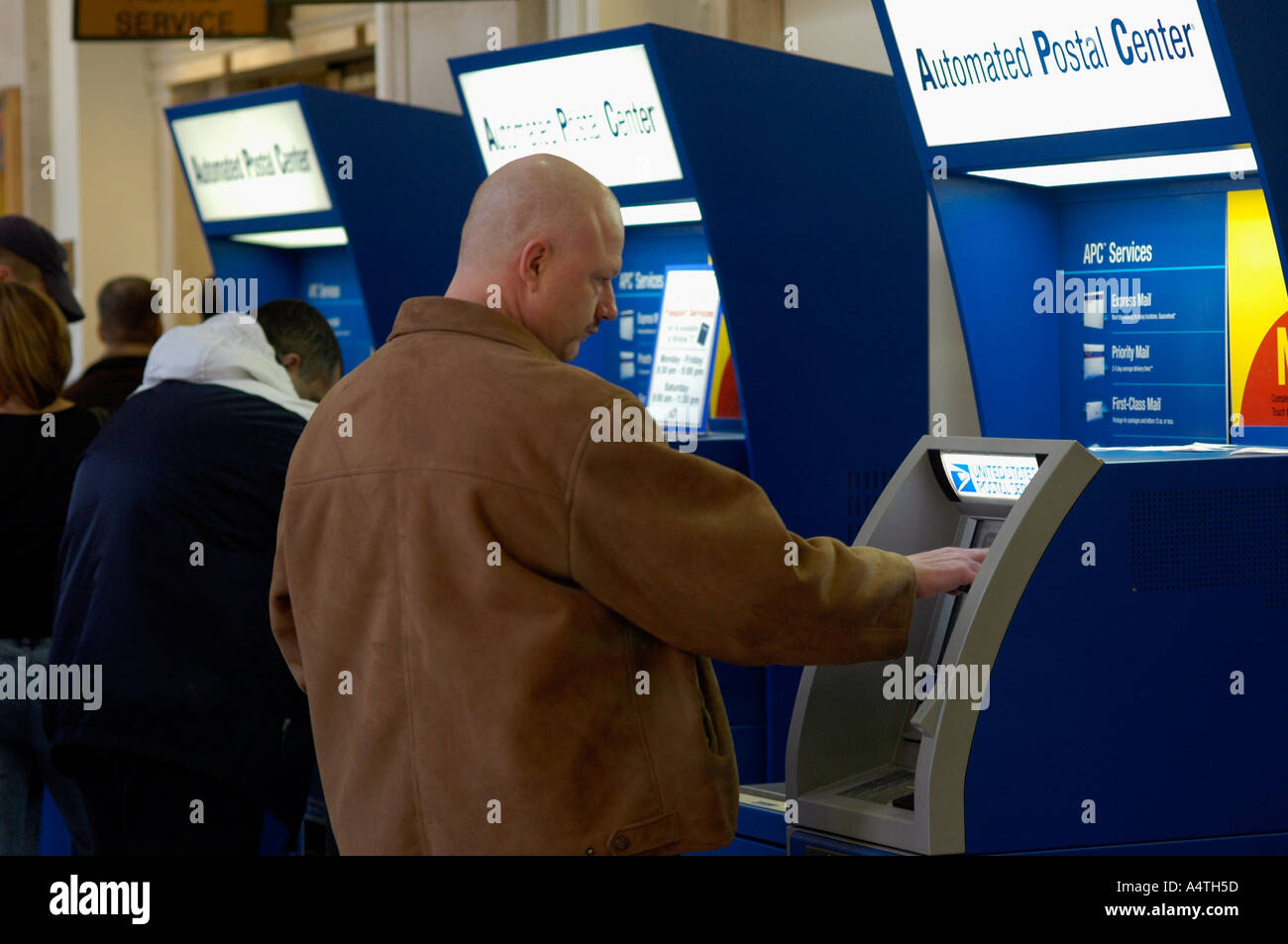 Taxpayers buy postage at Automated Postal Centers and wait on line at ...