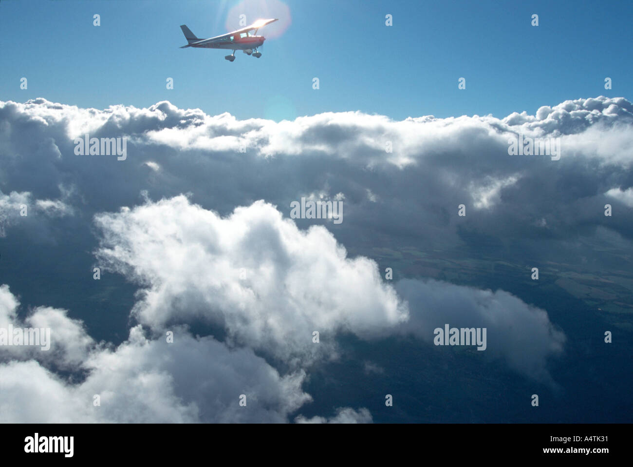 Light aircraft flying with blue sky and clouds Stock Photo - Alamy