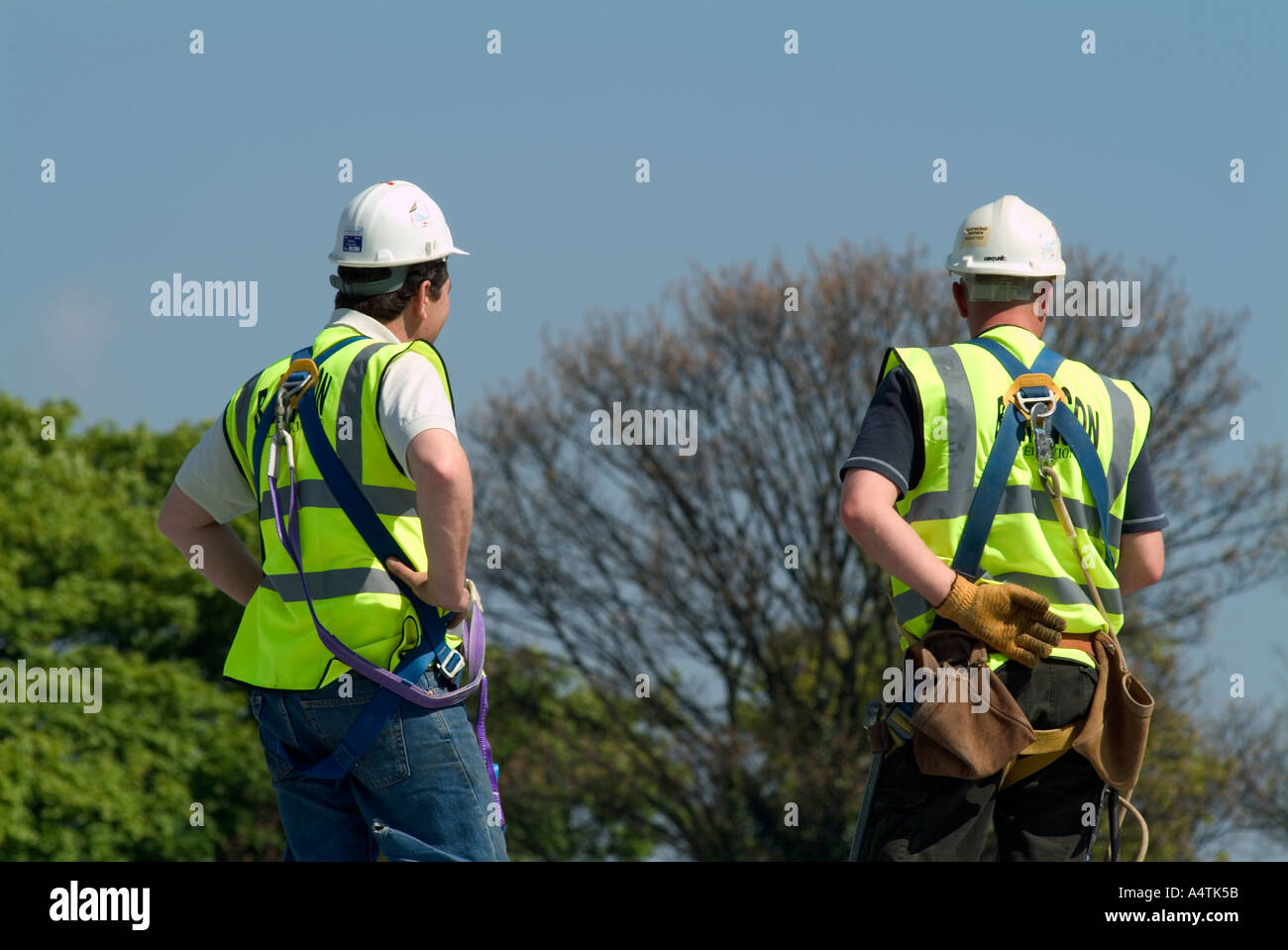 Two building site workers aloft new construction site, London, UK Stock ...