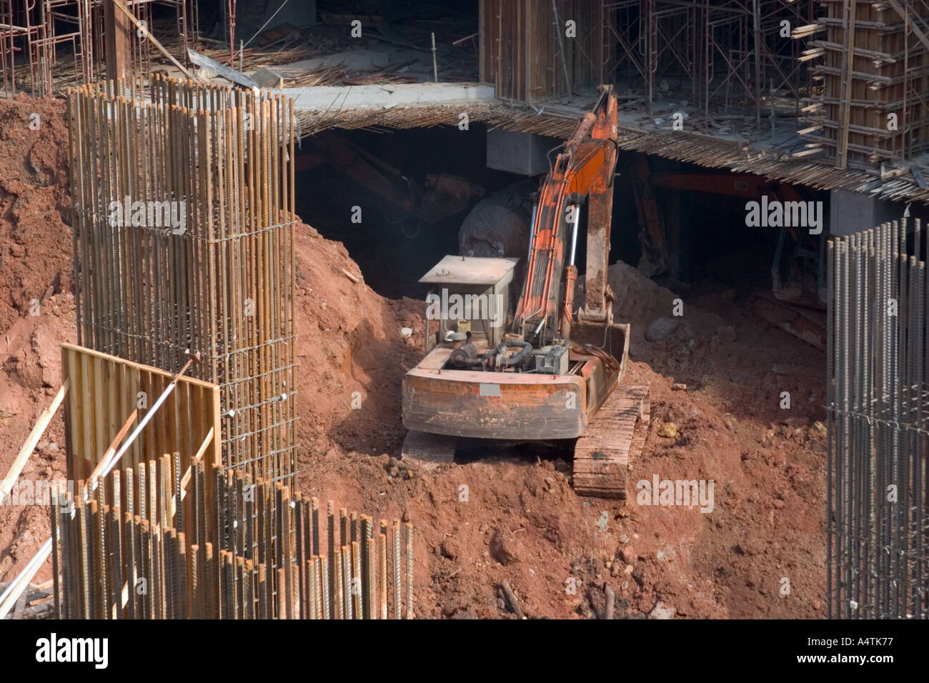 view of a building construction site under progress with excavator ...
