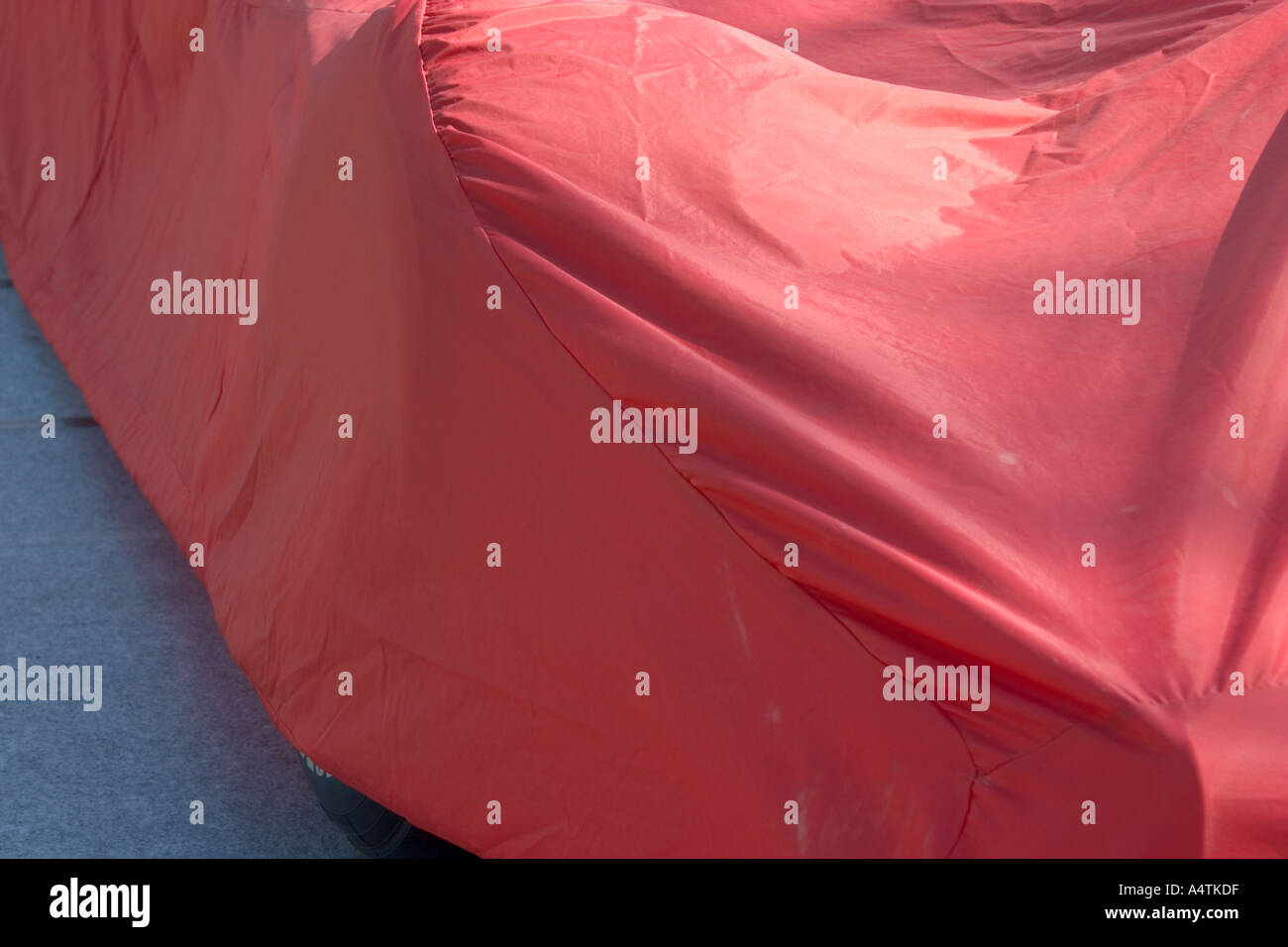 red plastic cover hiding something concept secrecy surprise Stock Photo ...