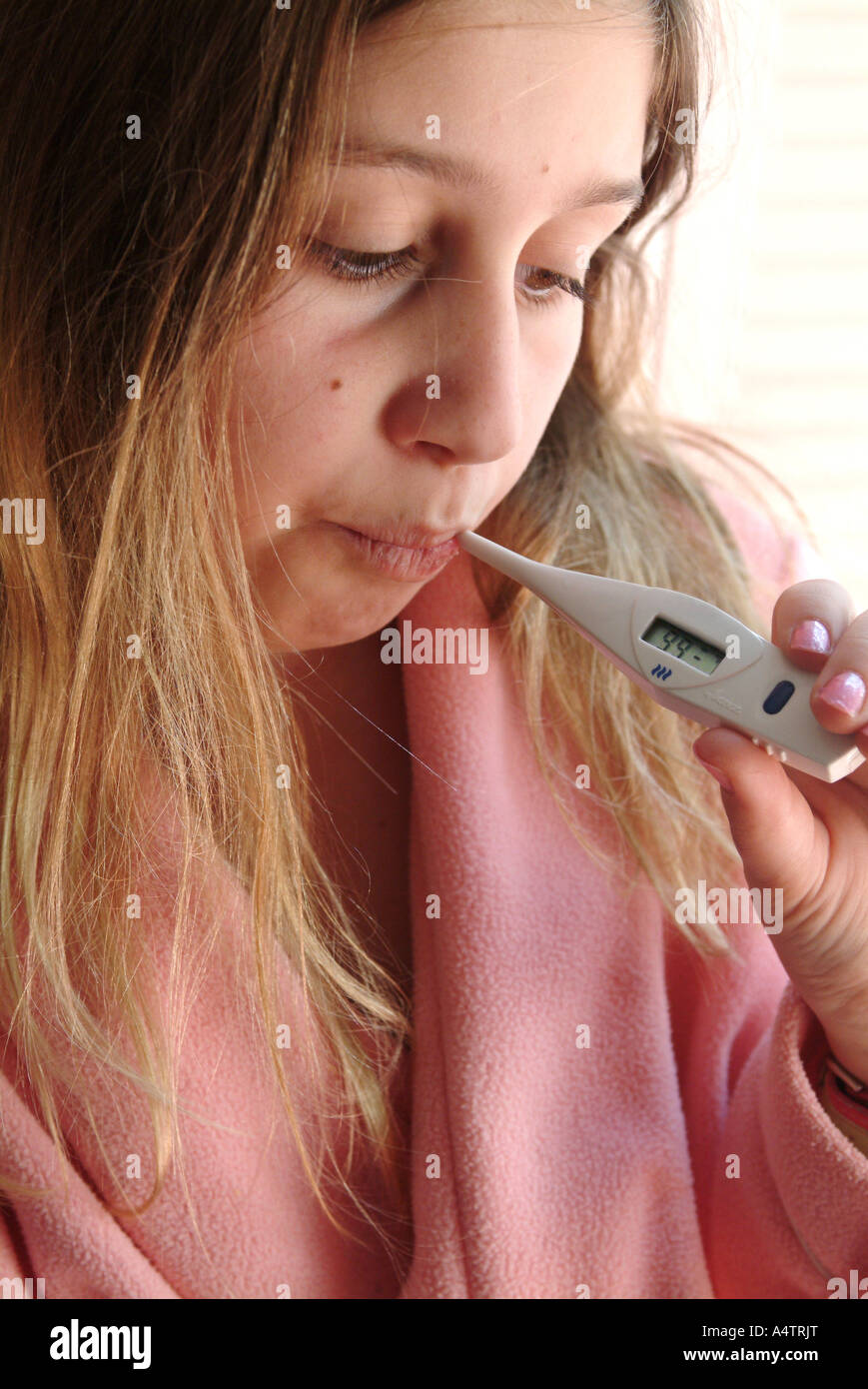 The girl has a slight fever with the thermometer reading 99 degrees ...