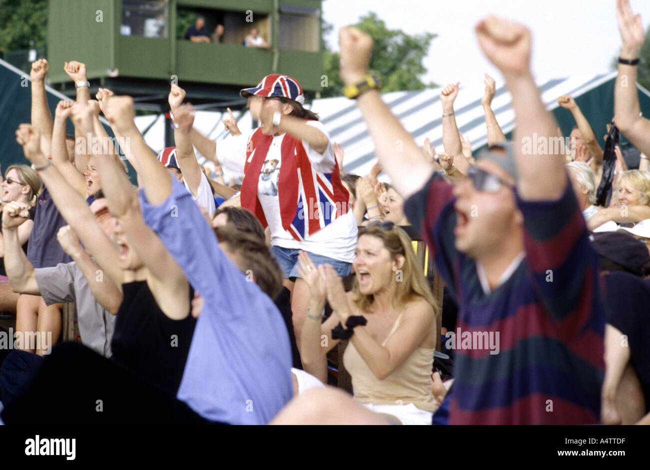 Crowd watching a screen and celebrating at the All England Tennis Club ...