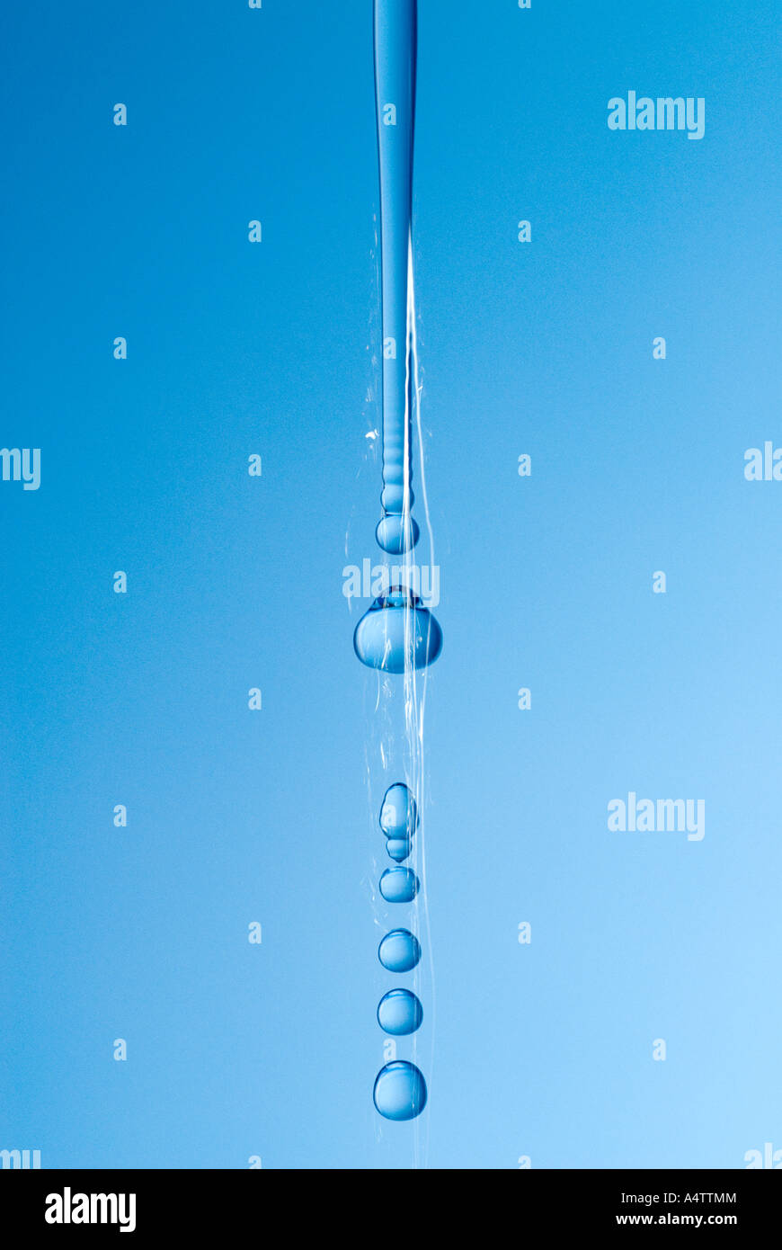 blue water drops falling in front of a blue and white background Stock ...