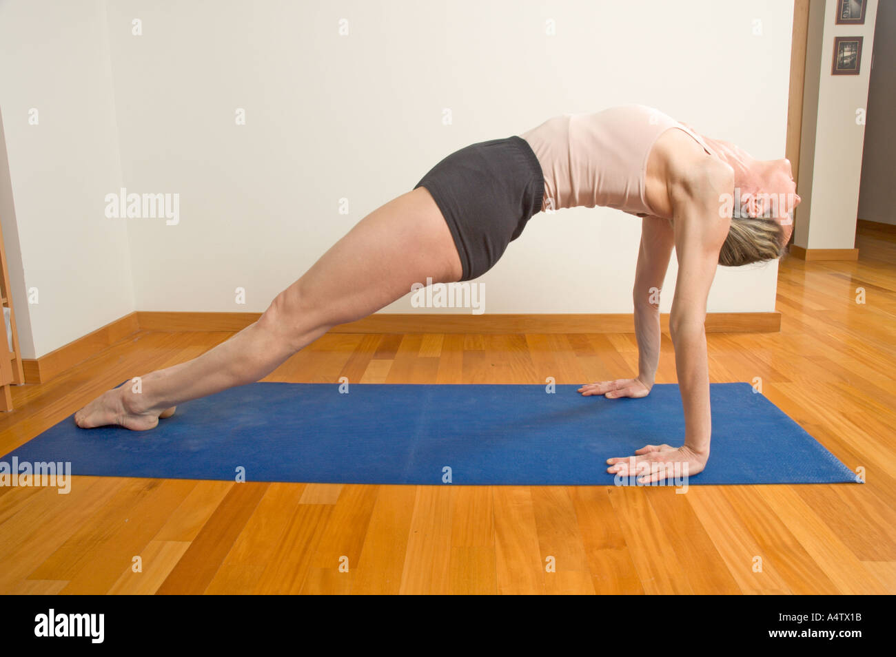 A woman practicing back bending yoga posture Iyengar yoga style Stock ...