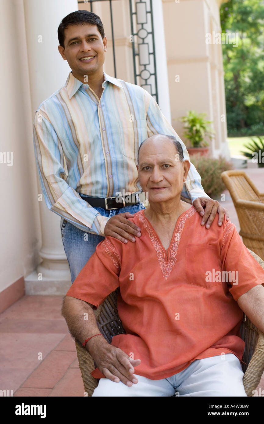 Man standing by his father Stock Photo - Alamy