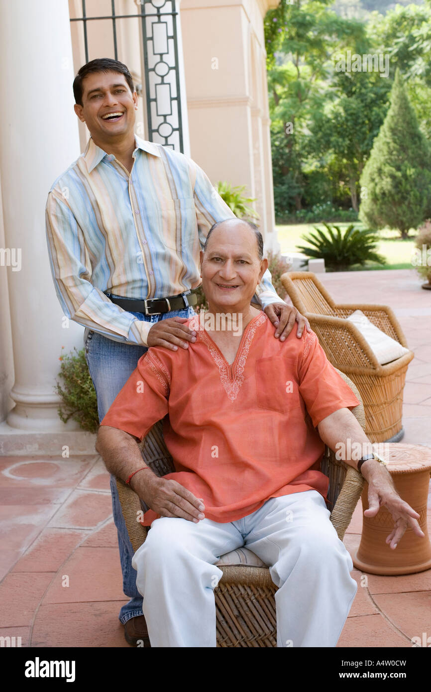 Man standing by his father Stock Photo - Alamy