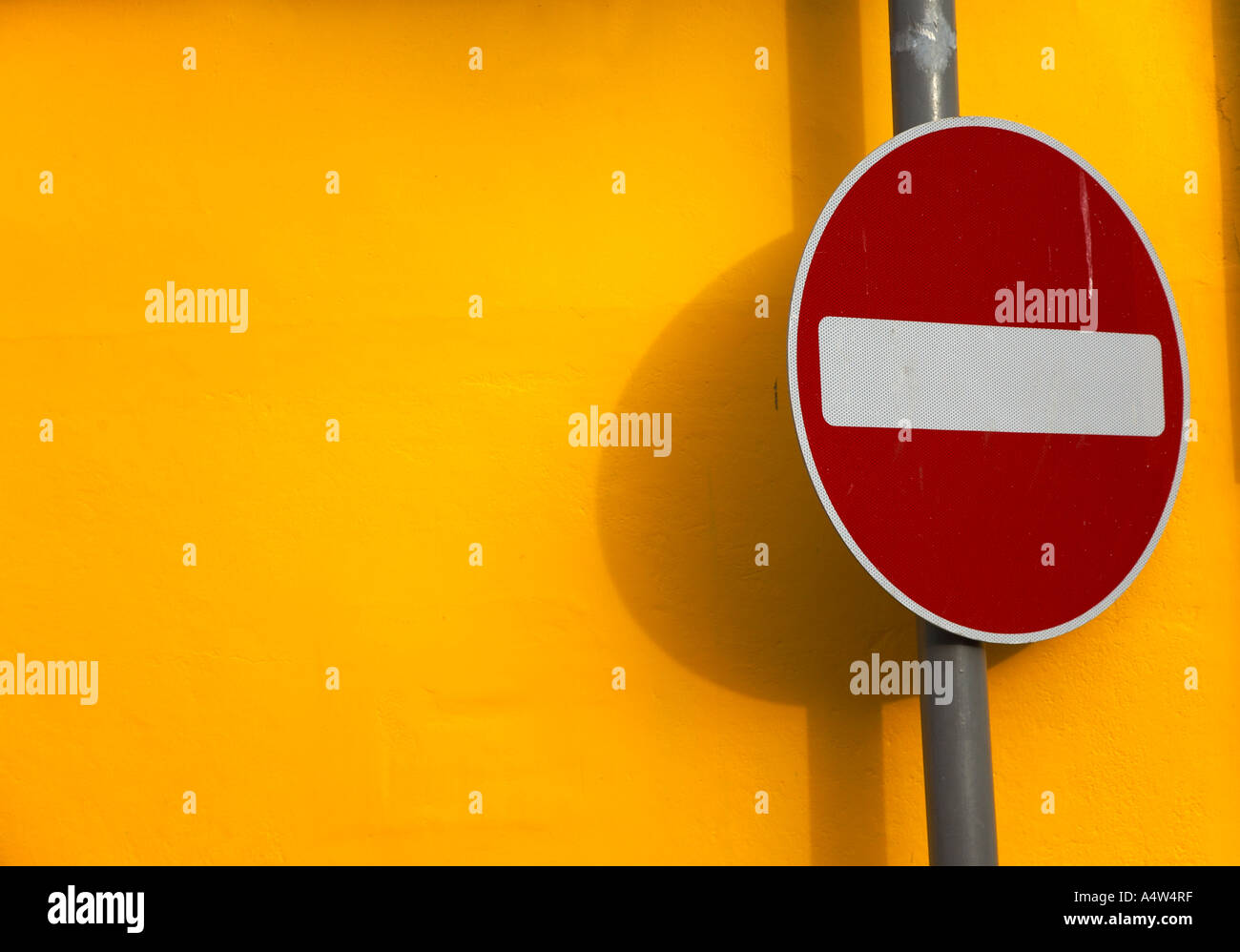 Highway stop sign and yellow wall England Stock Photo - Alamy