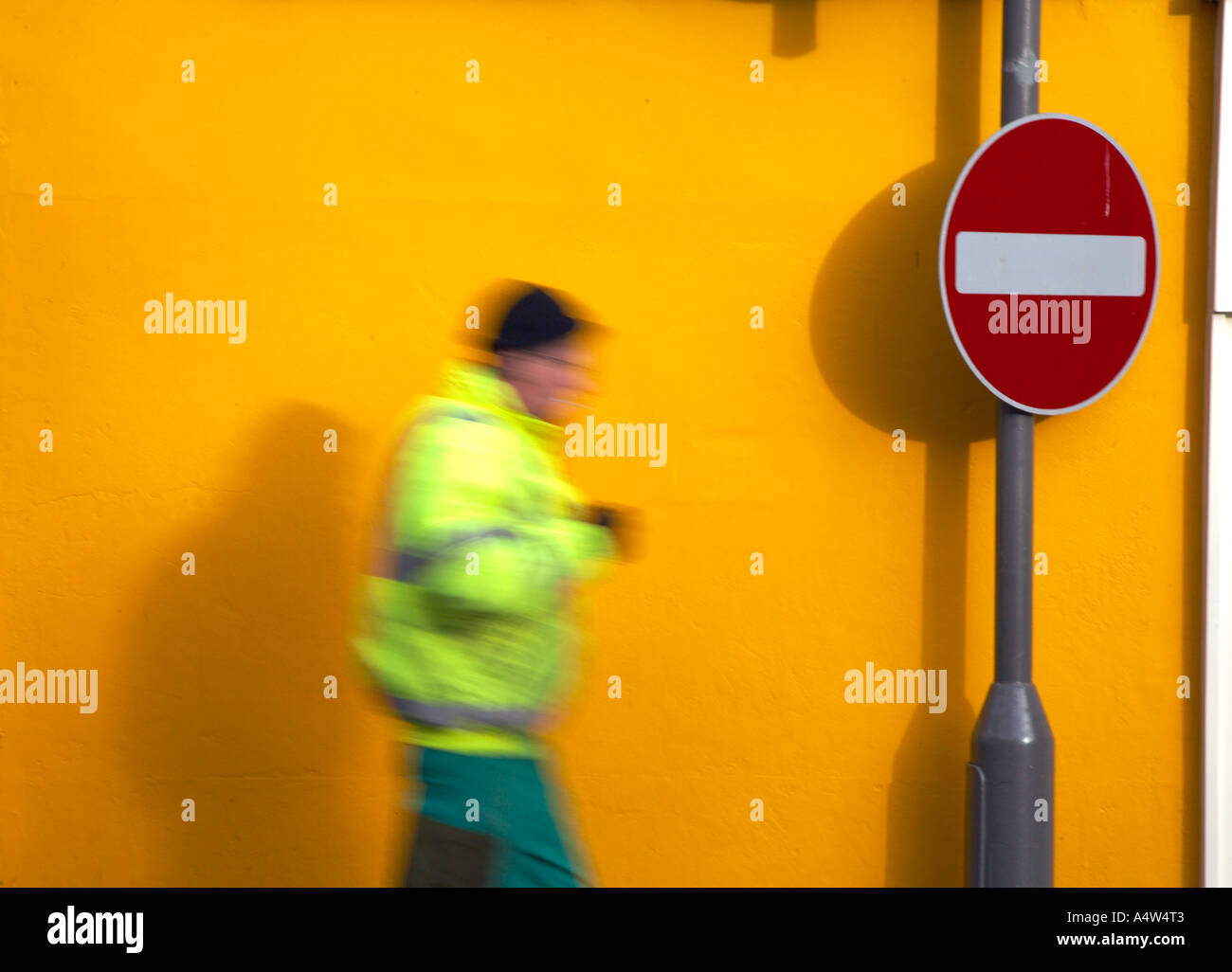 Highway stop sign and yellow wall England Stock Photo - Alamy